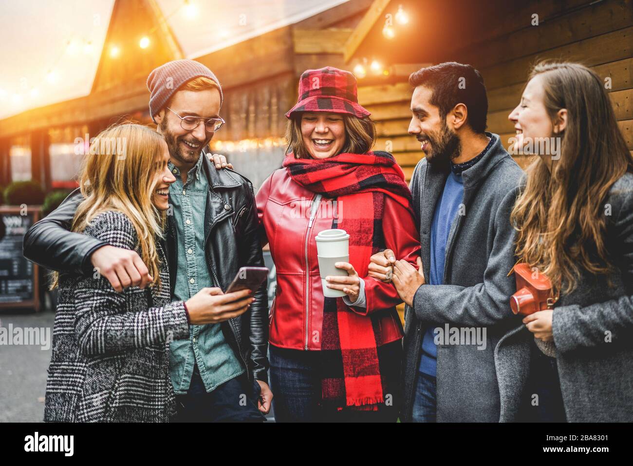 Happy young people having fun together out of vintage bakery ...