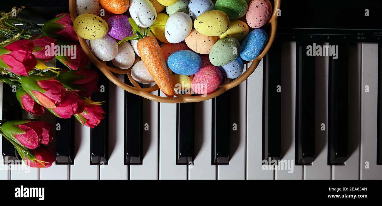 Colorful Paschal Easter Eggs and Piano Keys and Flowers Stock Photo - Alamy