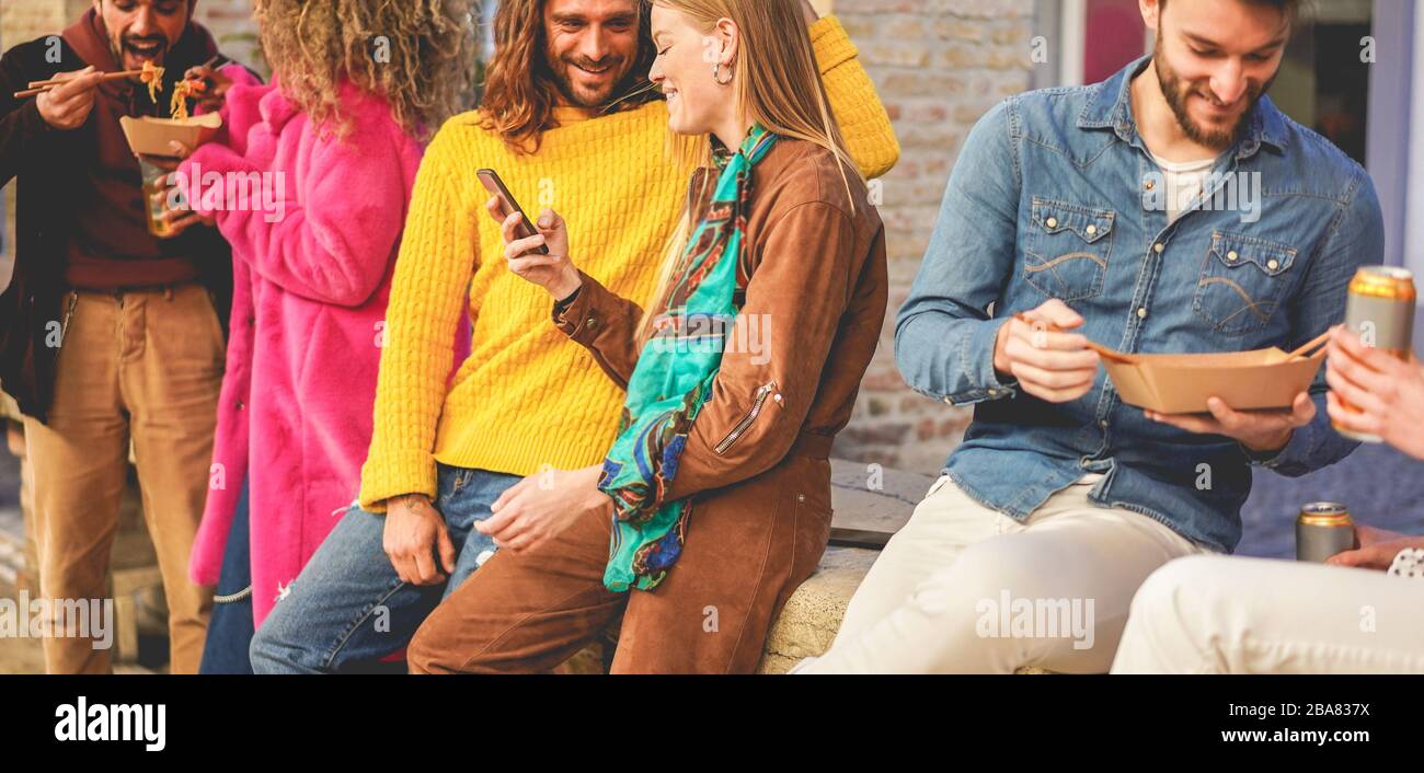 Happy friends eating street food outdoor - Young trendy people having ...