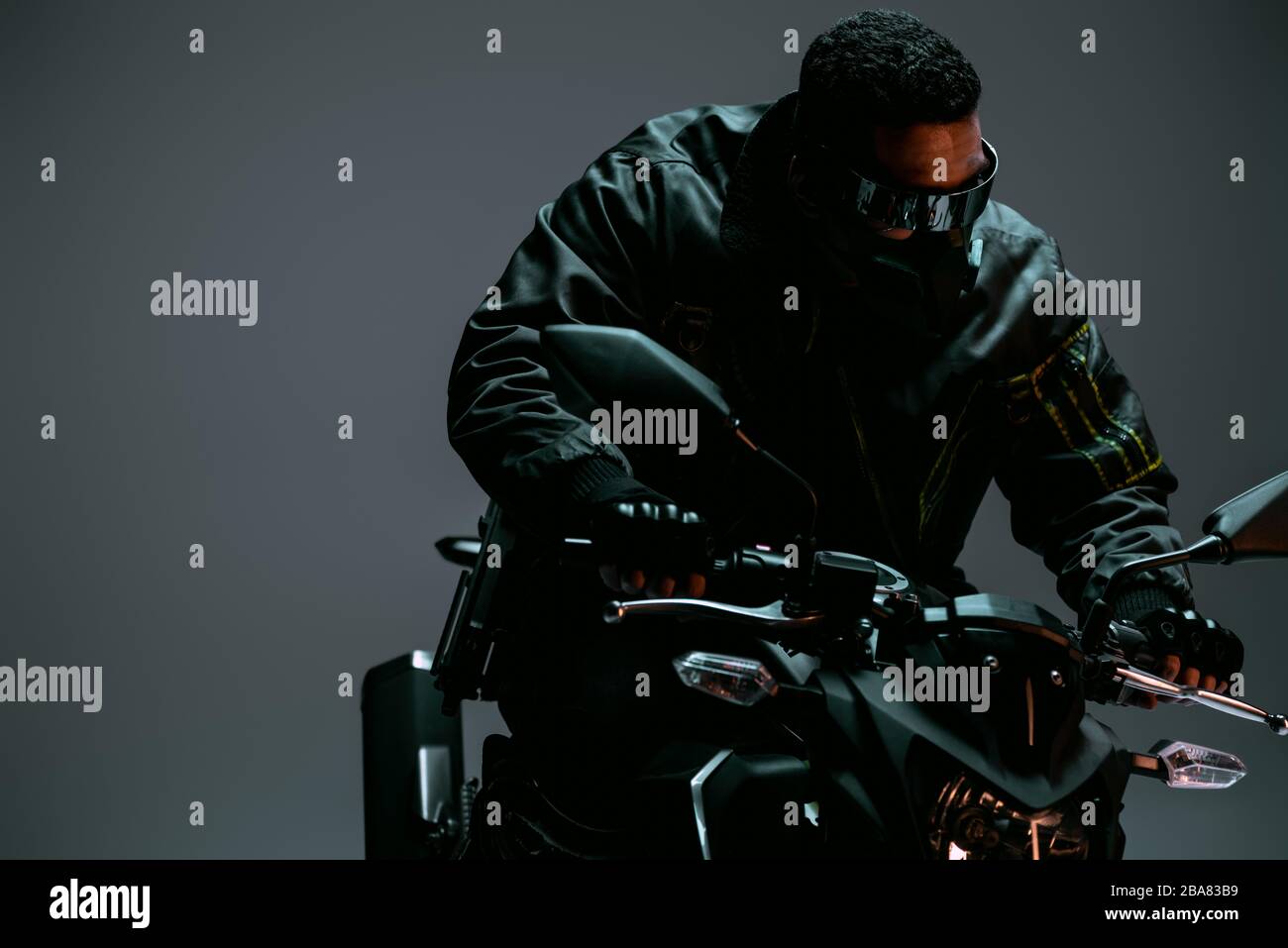 mixed race cyberpunk player in mask and futuristic glasses riding ...