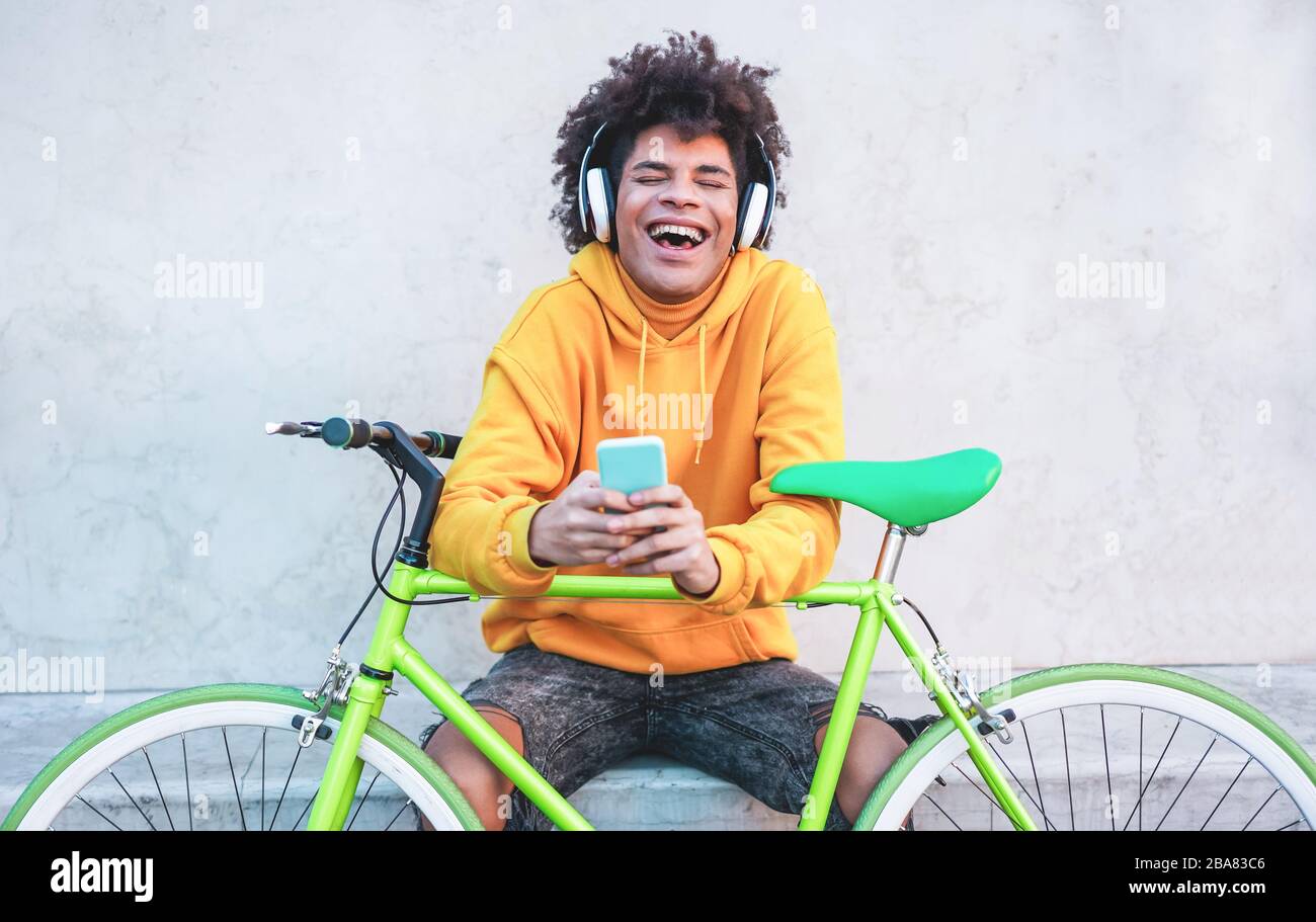 Happy african millennial guy listening music playlist with smartphone ...