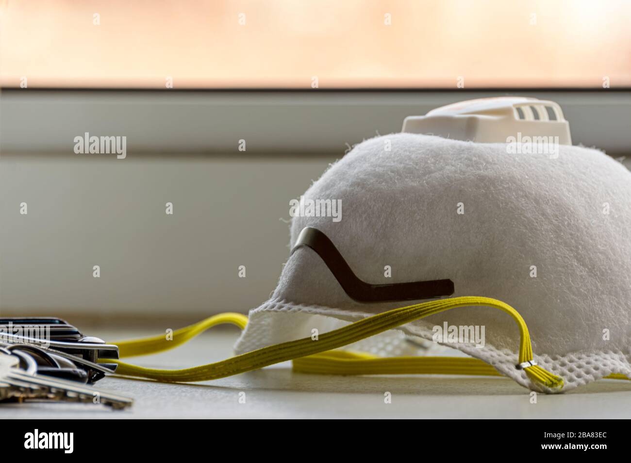 N95 Respirator Mask with keys and wallet on a counter at home. Personal ...