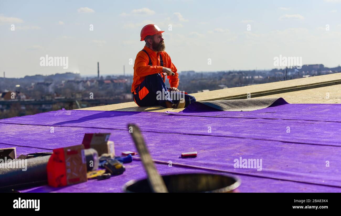 Successful engineer. worker special protective work wear. new roof ...