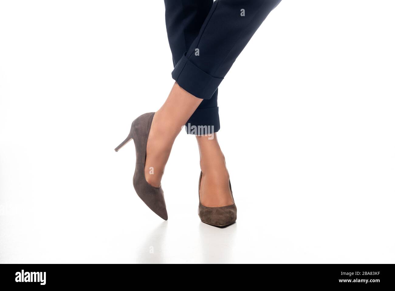 Cropped view of female crossed legs on white background Stock Photo - Alamy