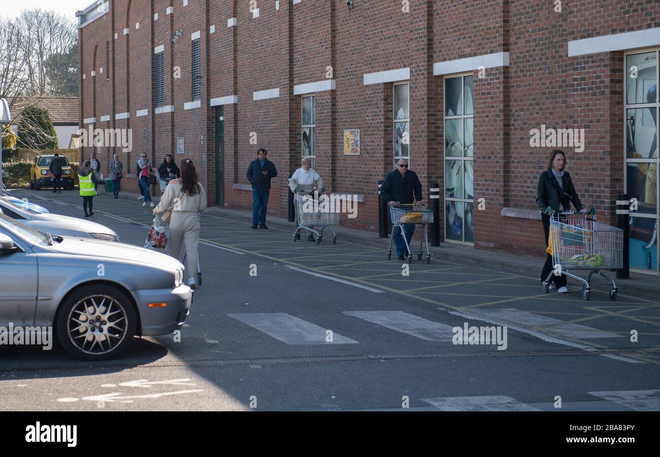 Sidcup, UK. 25th Mar, 2020. Shoppers queuing outside Morrisons in ...