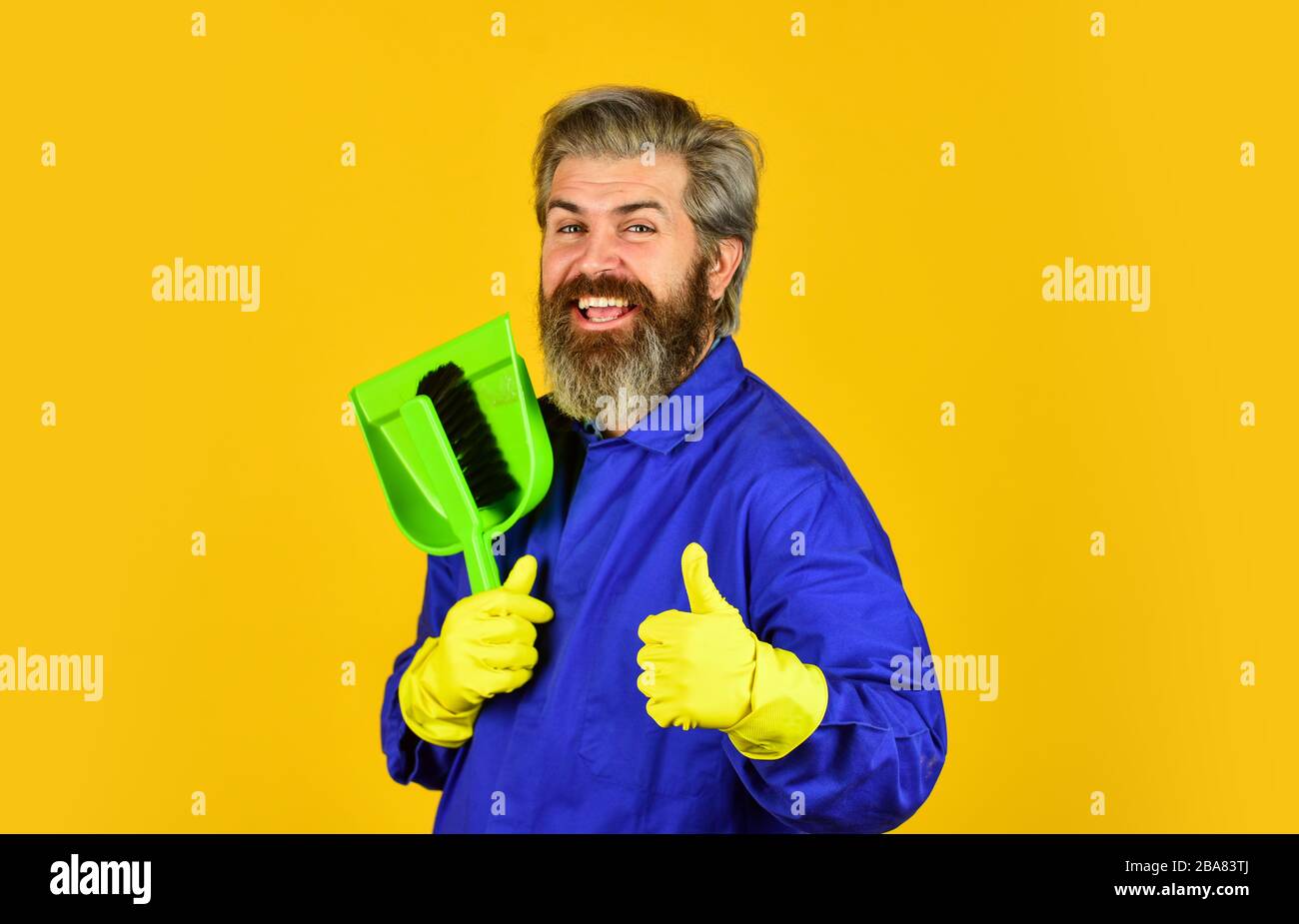 Changing responsibilities. Male janitor with cleaning supply. sweeping ...