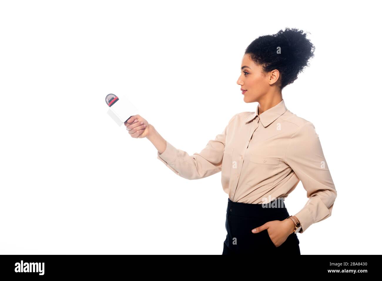 African american journalist with hand in pocket holding microphone in ...