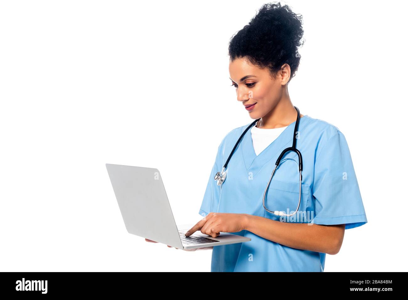 African american nurse with stethoscope focused on using laptop ...
