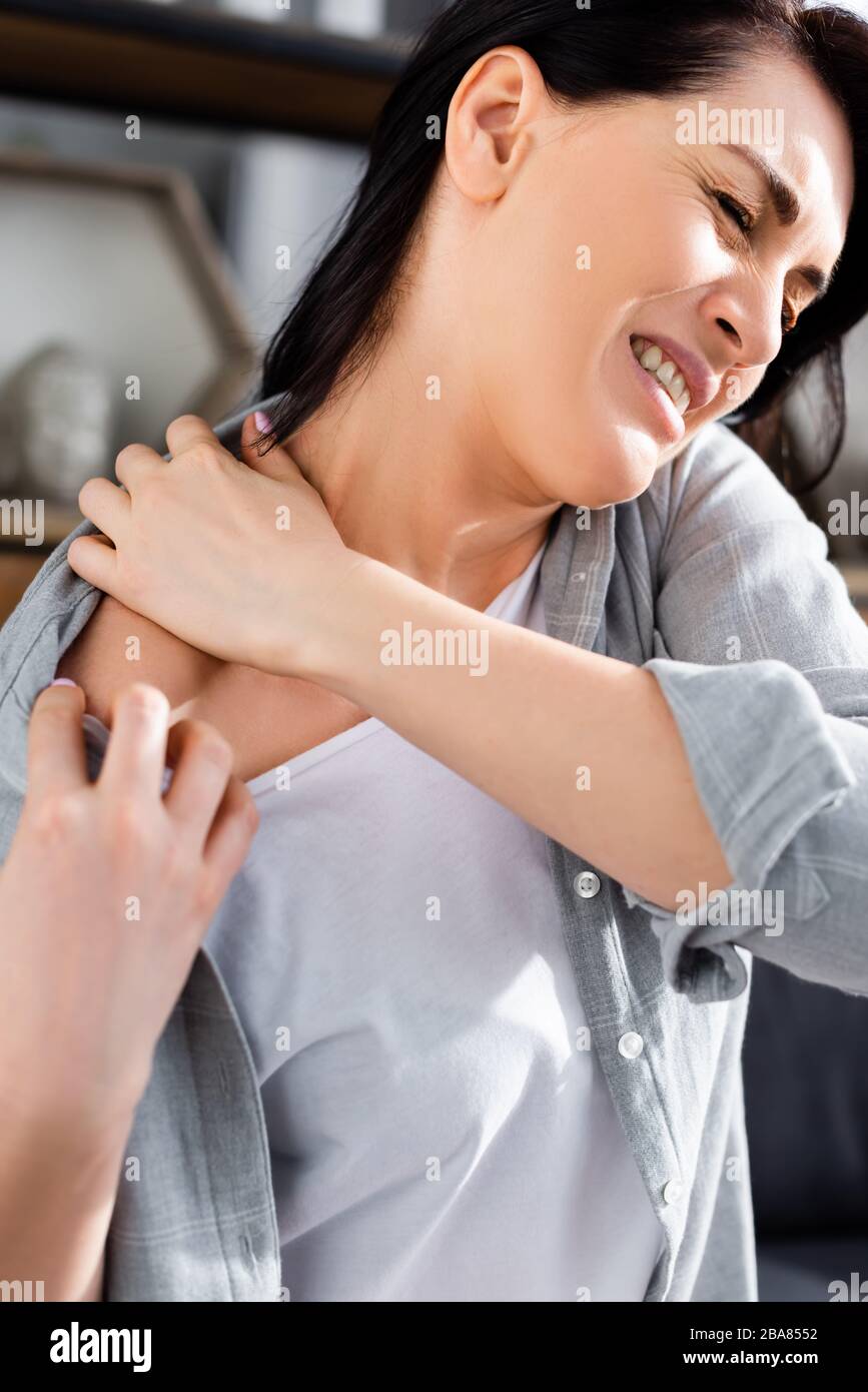 Woman scratching neck hi-res stock photography and images - Alamy