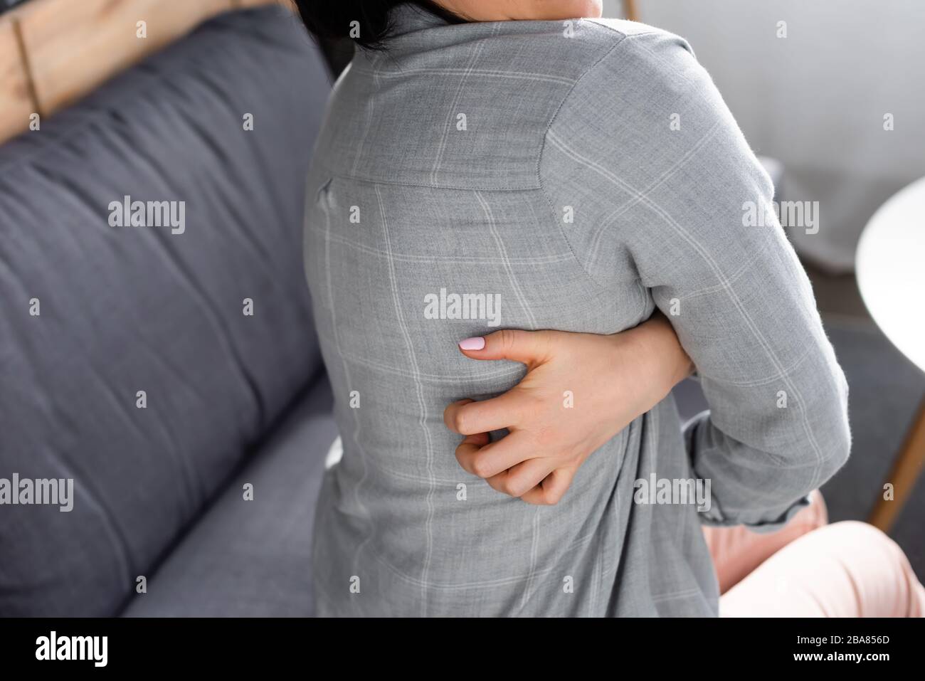 Woman scratching her back hi-res stock photography and images - Alamy
