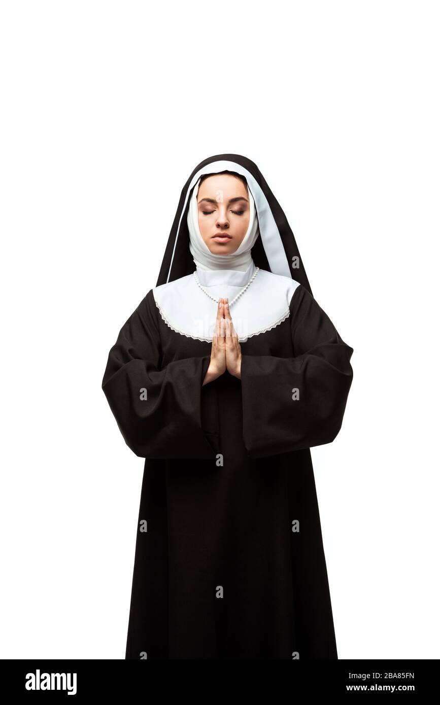 nun praying with closed eyes and hands together isolated on white Stock ...