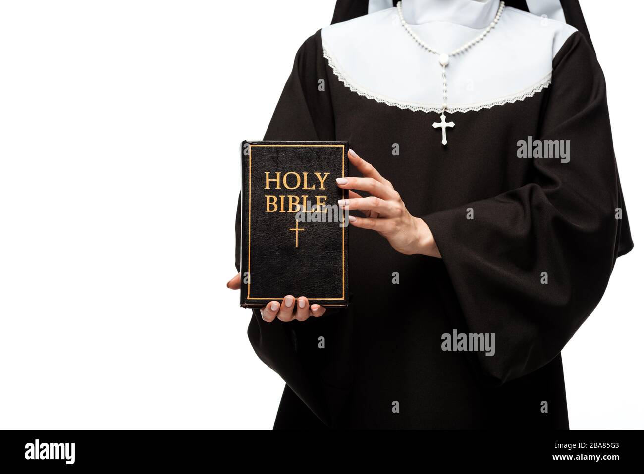 cropped view of nun holding holy bible isolated on white Stock Photo ...