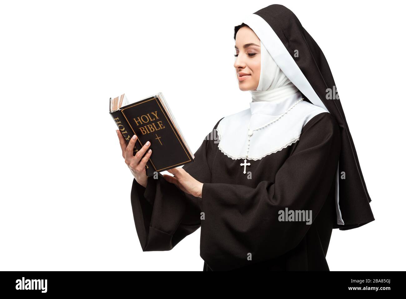 beautiful smiling nun holding holy bible isolated on white Stock Photo ...