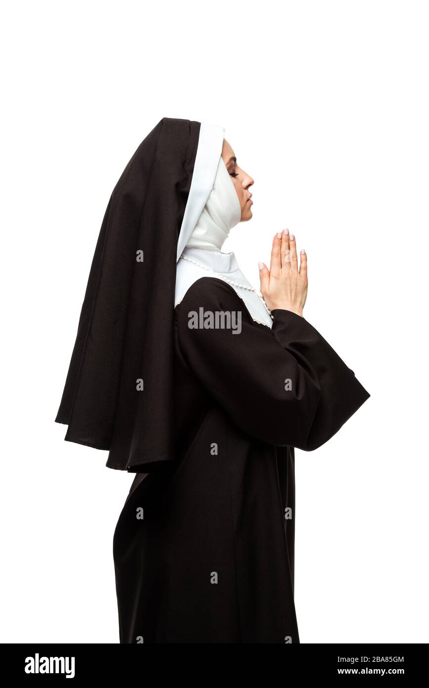 beautiful nun praying with closed eyes and hands together isolated on ...
