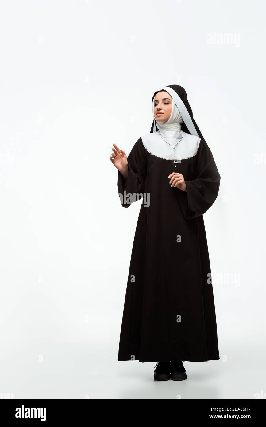 beautiful young happy nun standing on white Stock Photo - Alamy