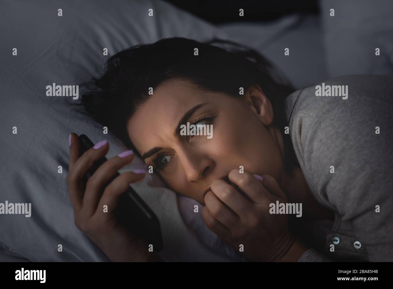 Woman scared in bed at night hi-res stock photography and images - Alamy