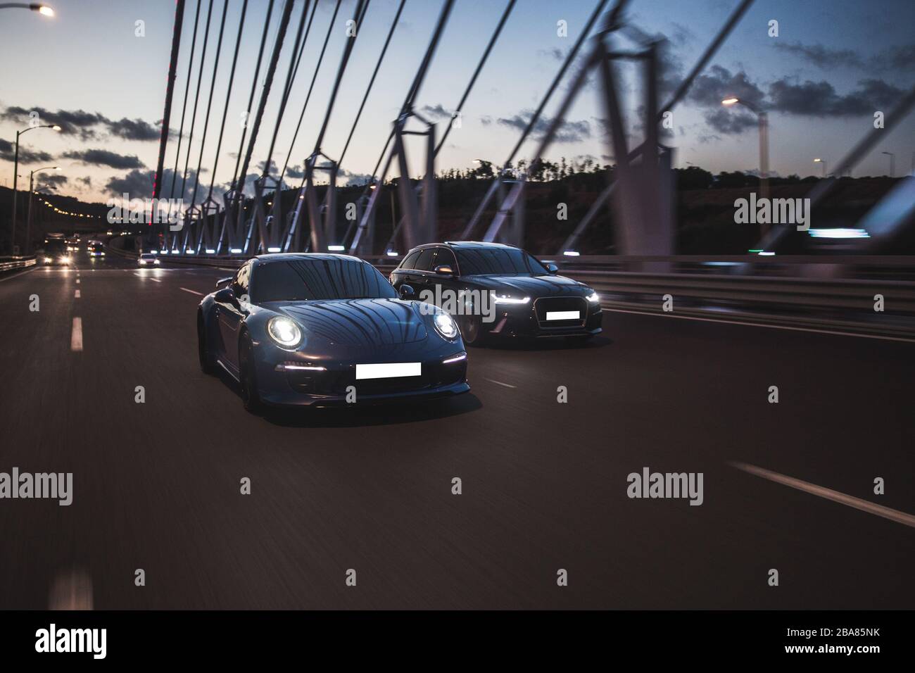 Sport cars driving on the bridge in the evening Stock Photo - Alamy