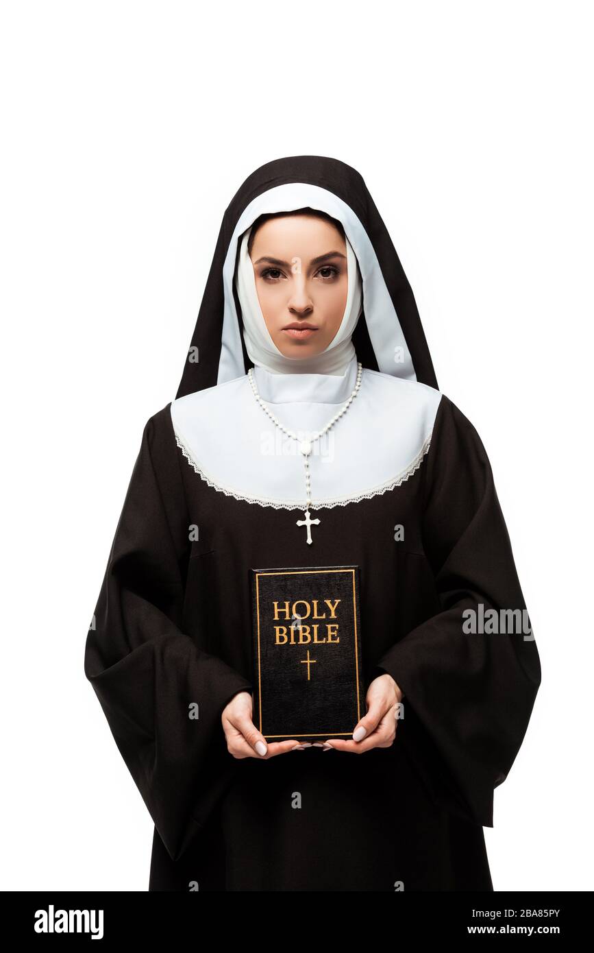 beautiful serious nun holding holy bible isolated on white Stock Photo ...