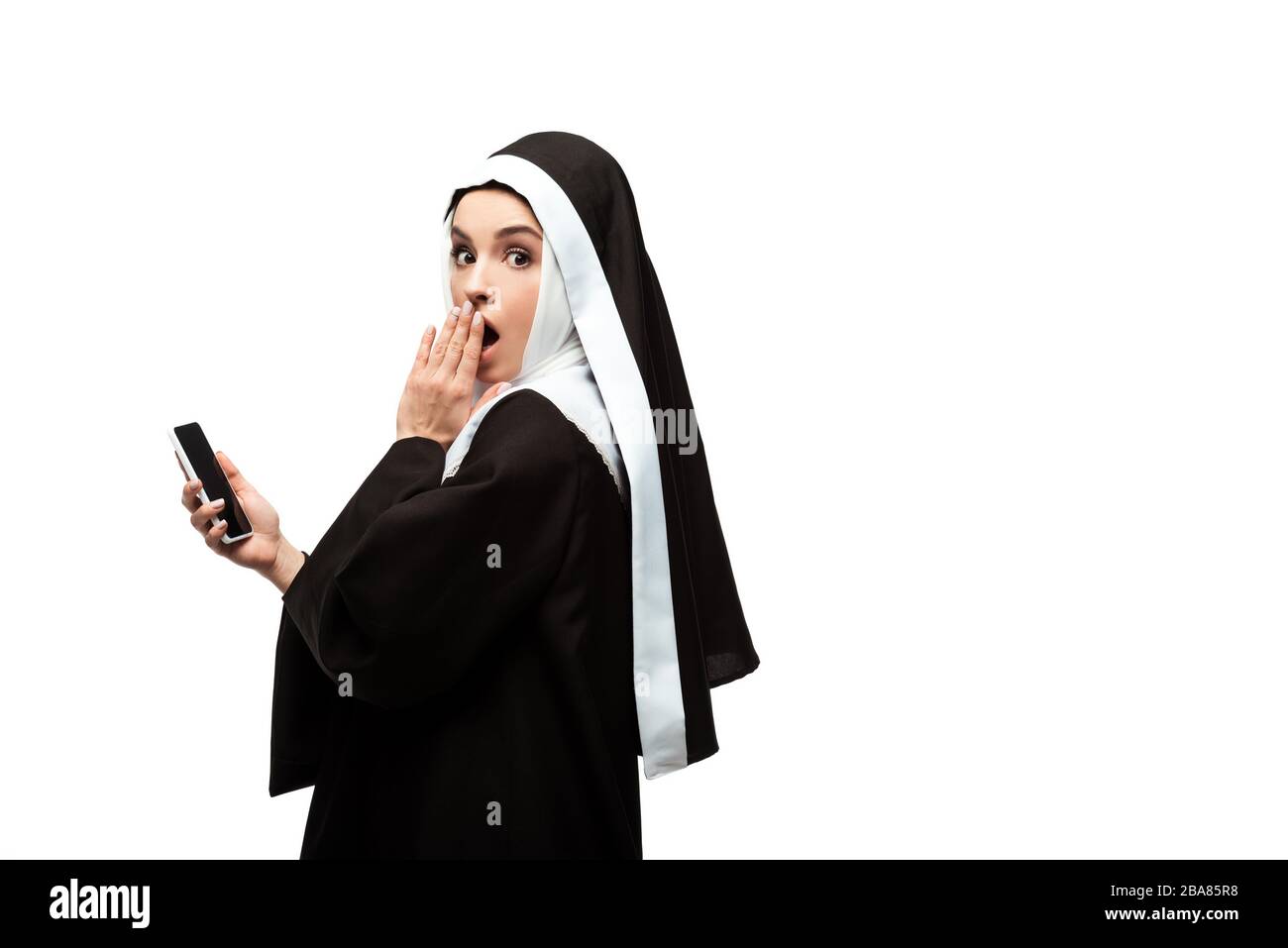 Beautiful Surprised Nun Using Smartphone Isolated On White Stock Photo