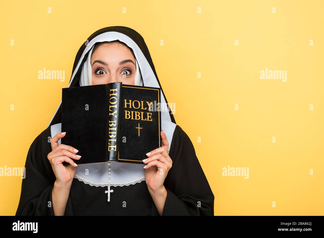 shocked nun reading holy bible isolated on grey Stock Photo - Alamy