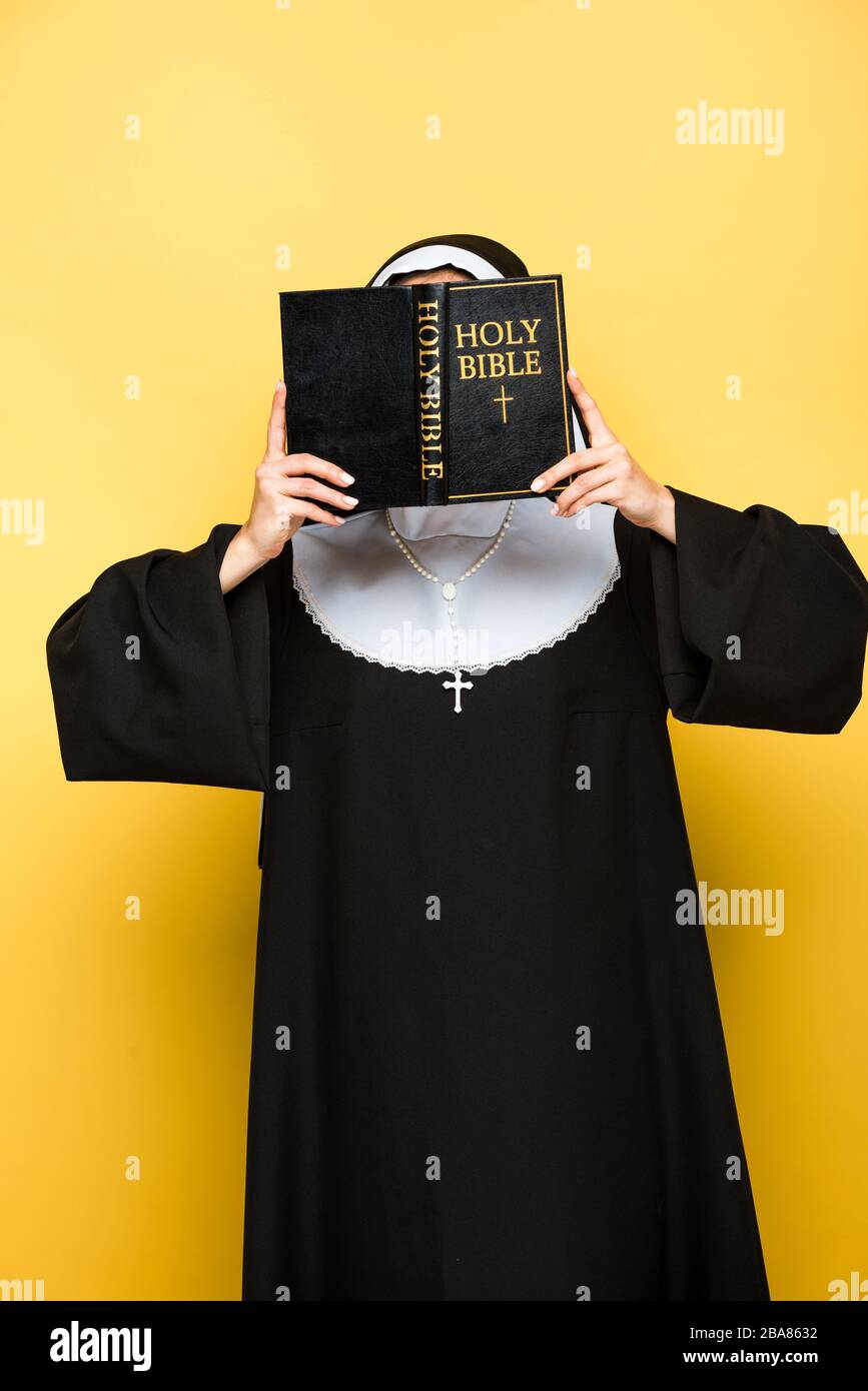 young nun reading holy bible on grey Stock Photo - Alamy