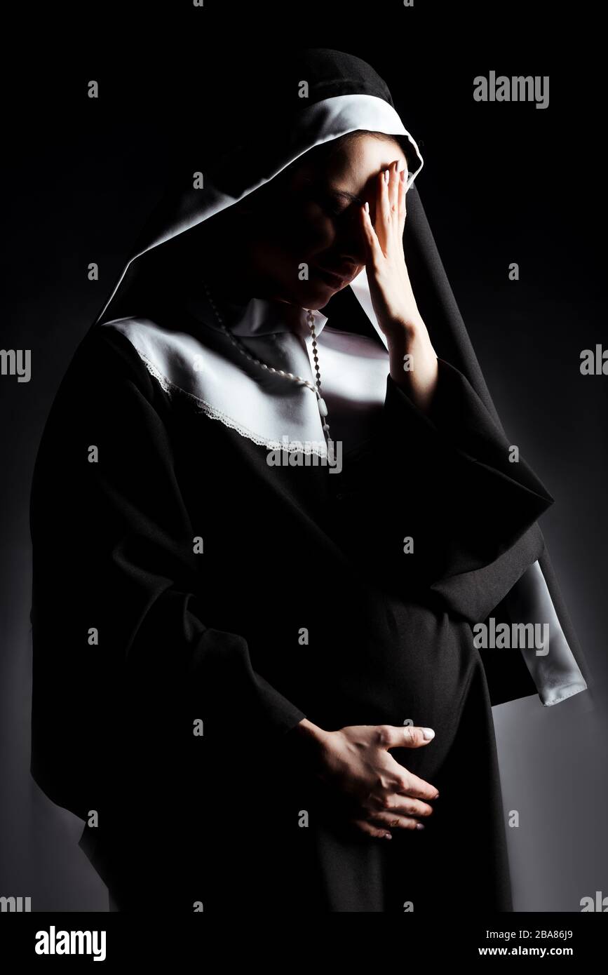 sad crying pregnant nun touching tummy on grey Stock Photo - Alamy