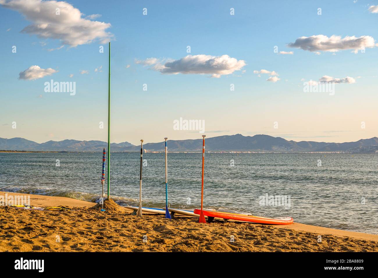 Paddle boards on the beach and a flag pole at Sant Marti, L'Escala ...
