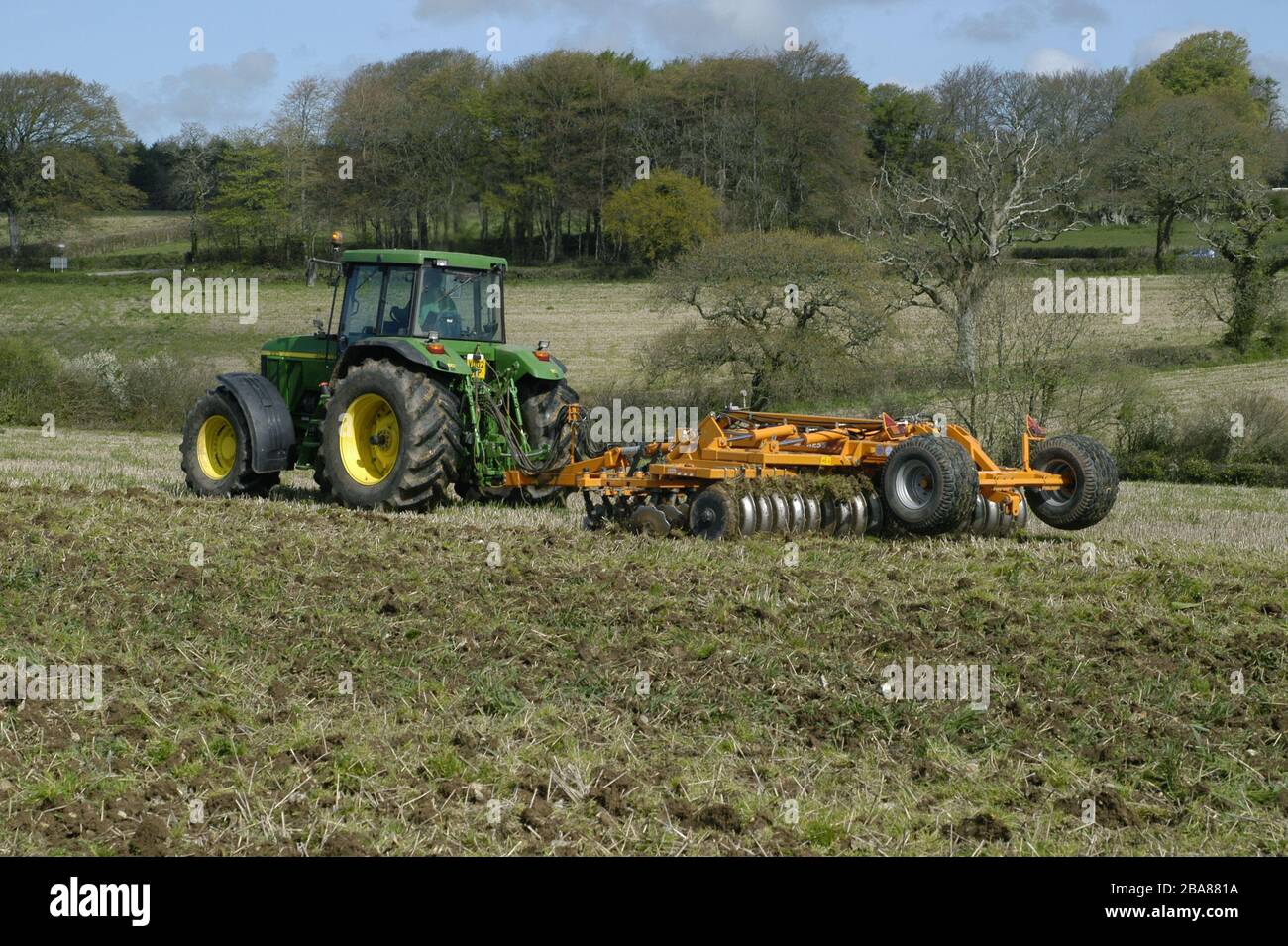 John Deere tractor with a Simba power disc harrow cultivating set-a ...