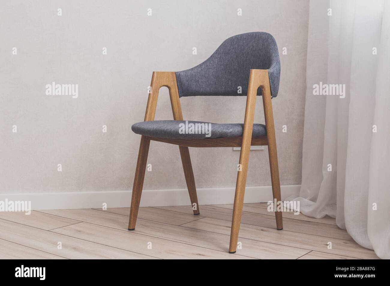 Modern grey chair with white brick walls on background and wood floor ...