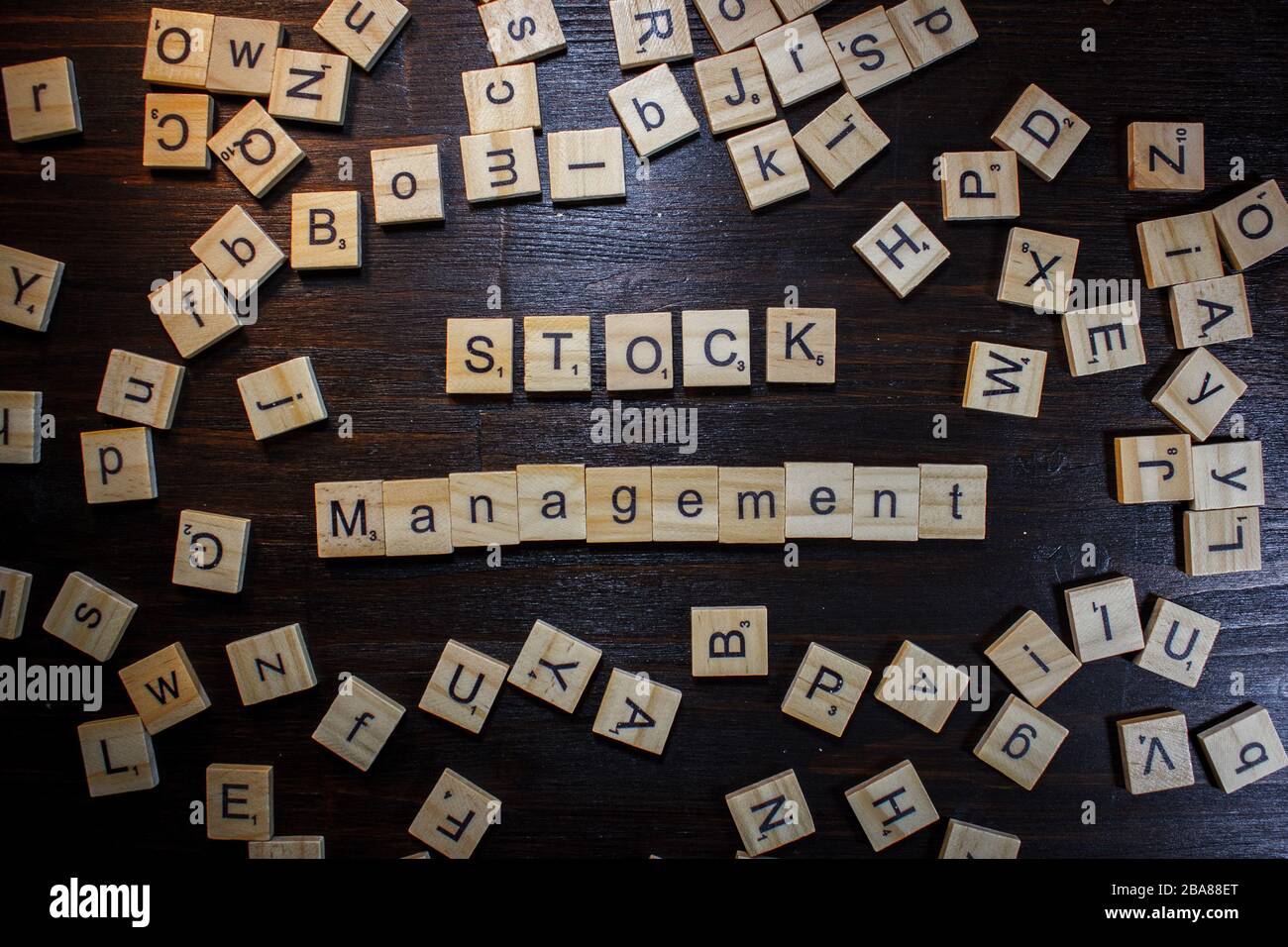 Word or phrase Stock Management made with scrabble letters on black ...