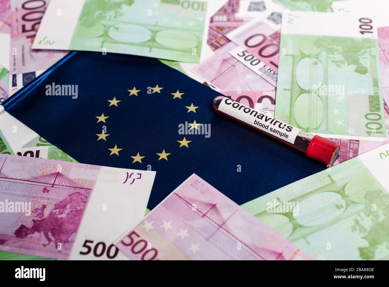euro banknotes, European flag and coronavirus blood sample Stock Photo ...