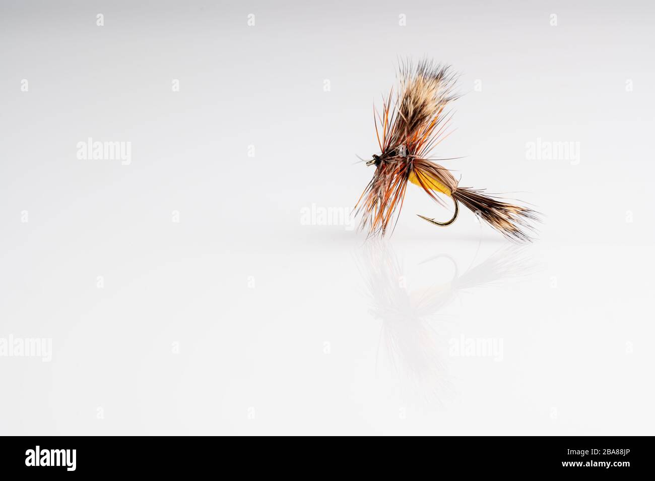 Traditional Yellow Humpy Dry Fly Fishing fly against a white background ...
