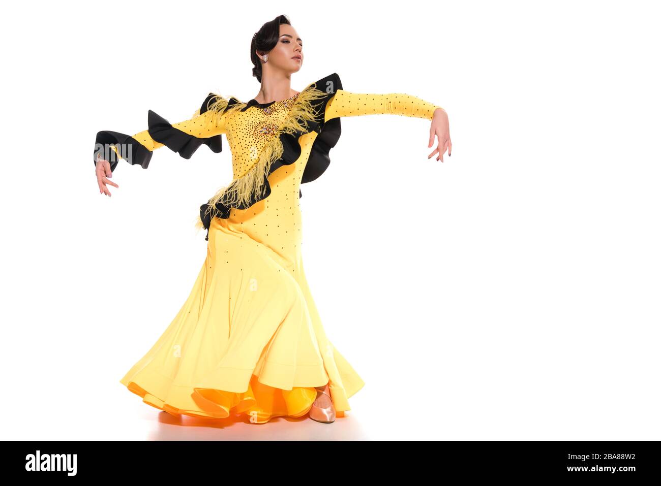 elegant young ballroom dancer in yellow dress dancing on white Stock ...