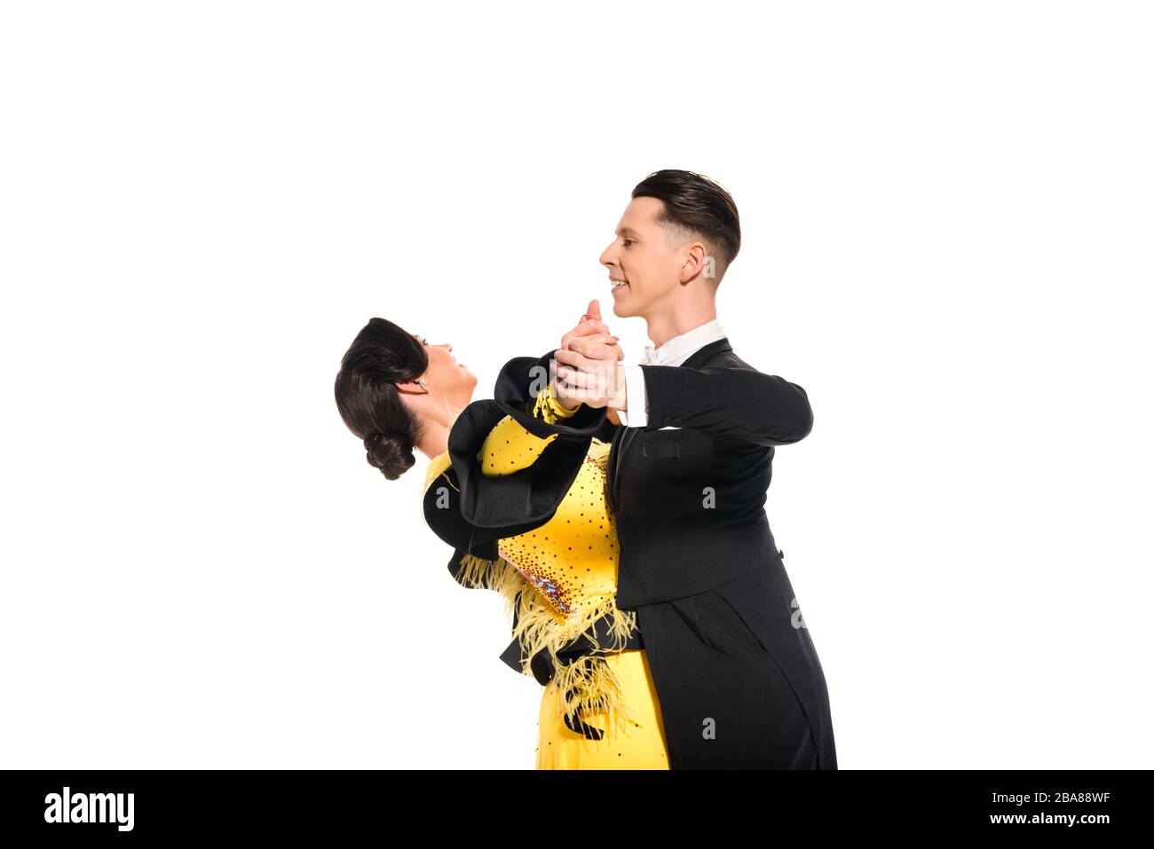 side view of elegant young couple of ballroom dancers in yellow dress ...