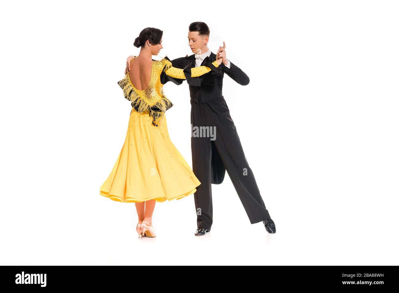 elegant young couple of ballroom dancers dancing isolated on white ...