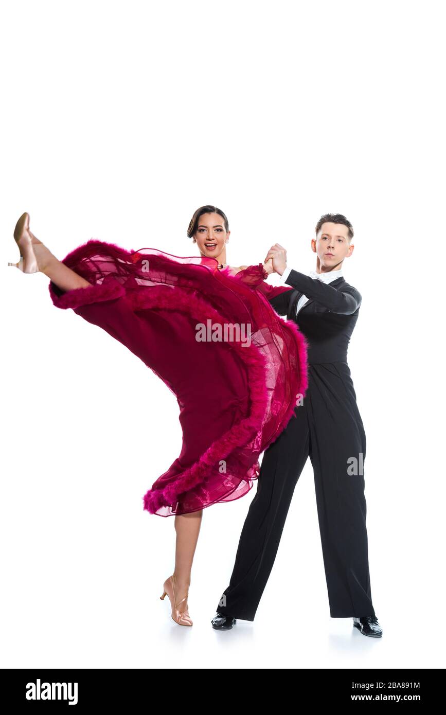 elegant young couple of ballroom dancers in red dress in suit dancing ...