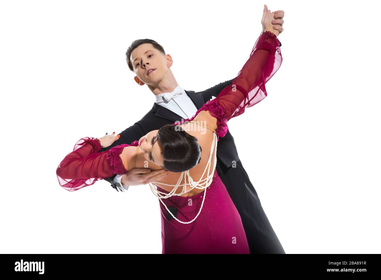 elegant young couple of ballroom dancers in red dress in suit dancing ...