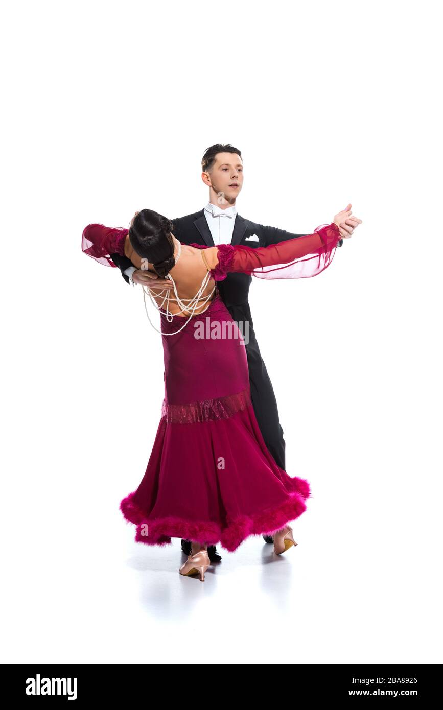 elegant young couple of ballroom dancers in red dress in suit dancing ...