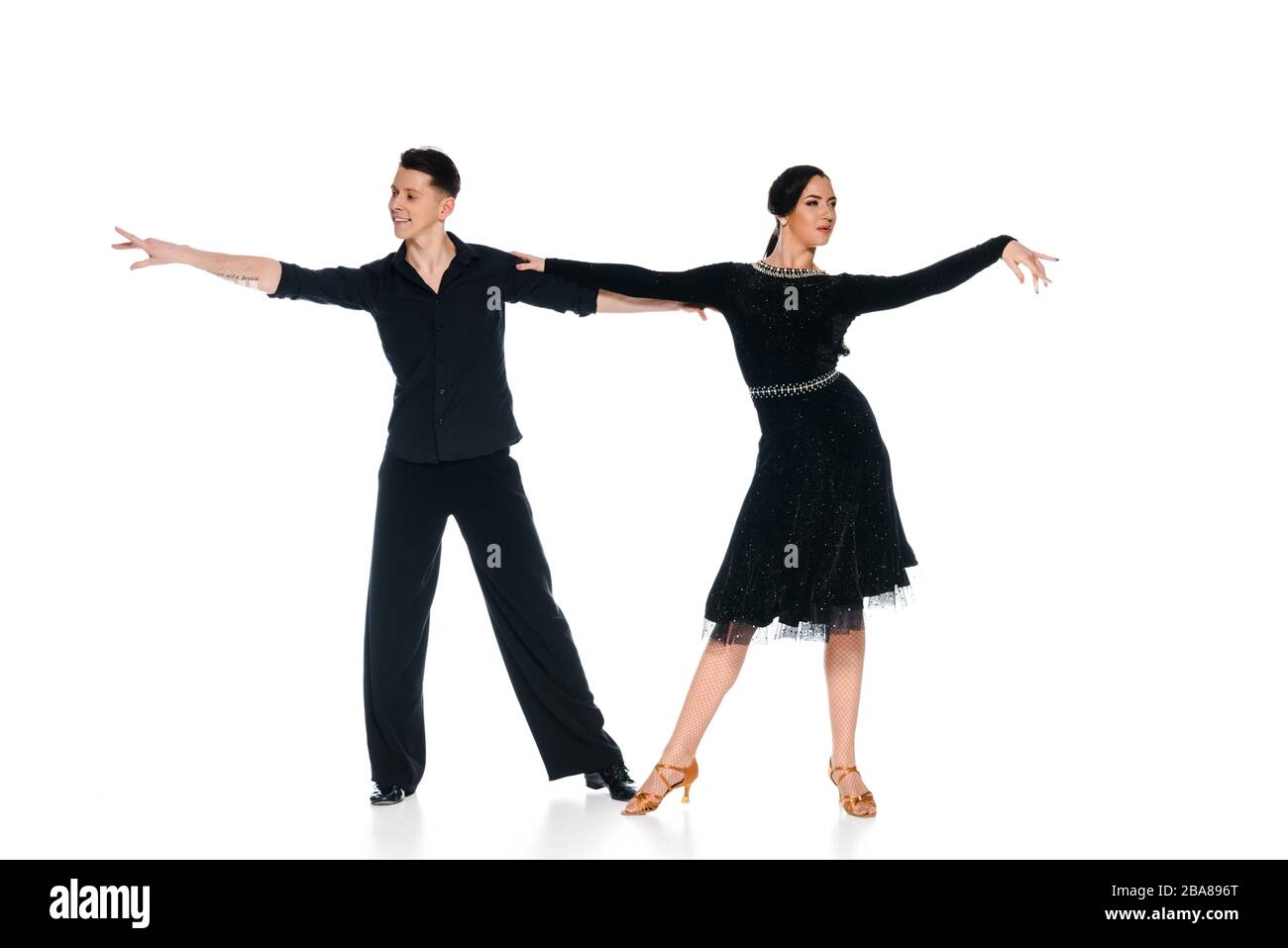 elegant young couple of ballroom dancers in black dress and suit ...