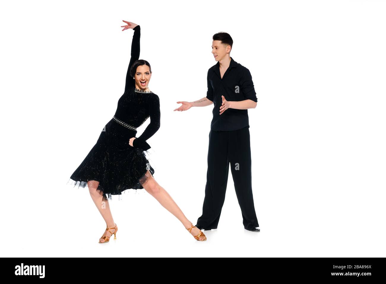 elegant young couple of ballroom dancers in black dress and suit ...
