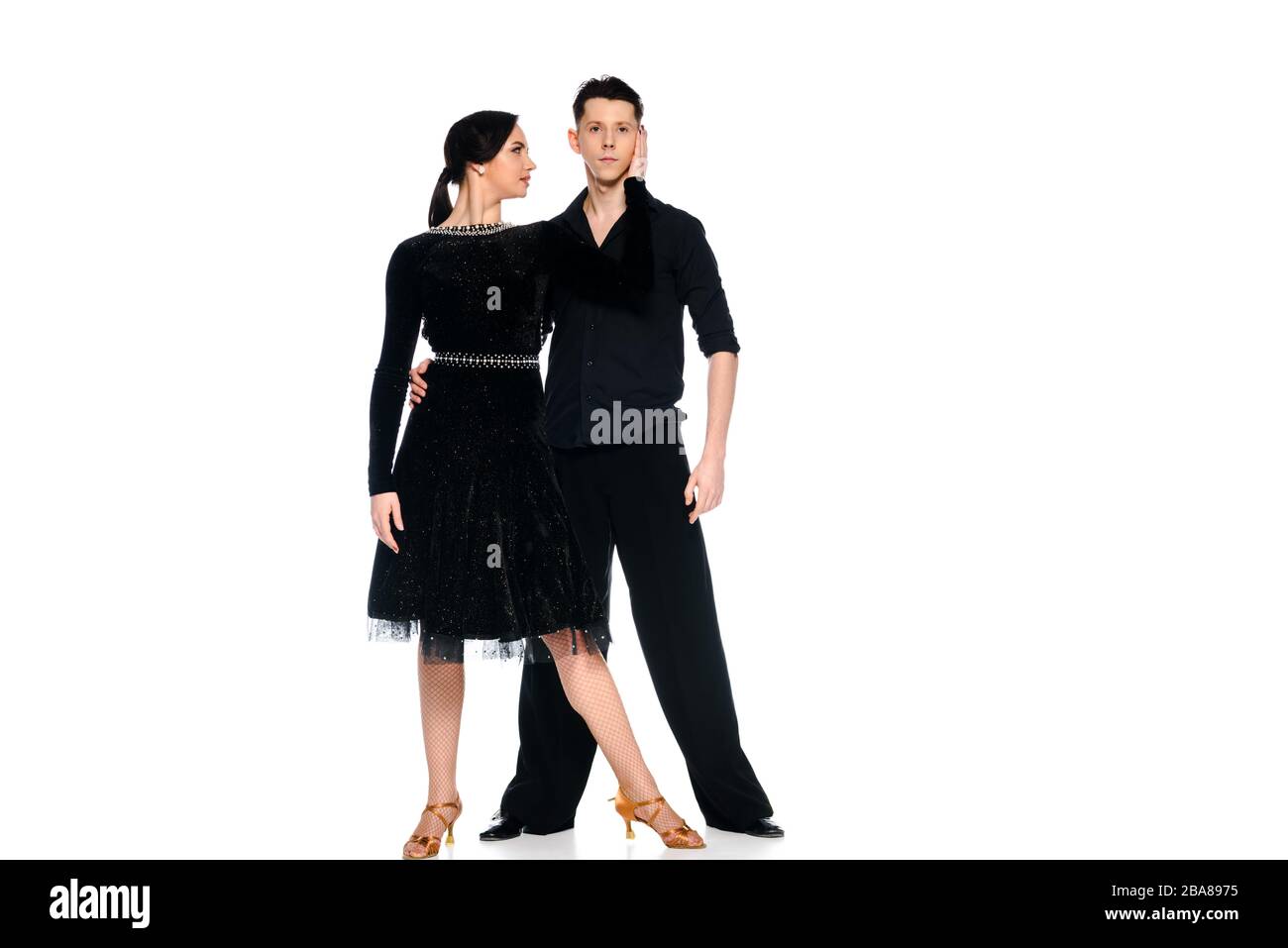 elegant young couple of ballroom dancers in black dress and suit ...