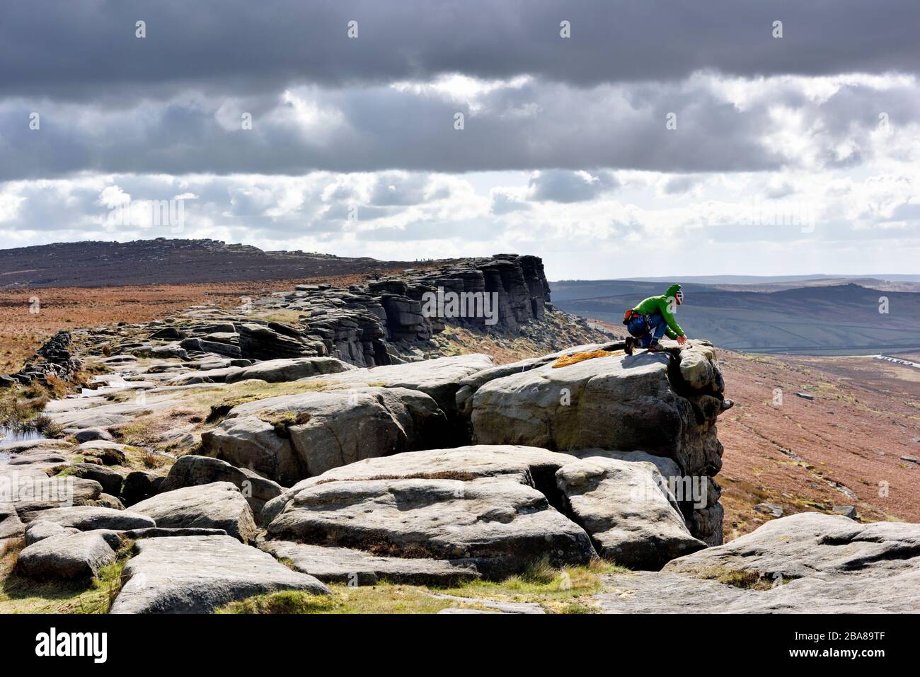 Rock Climber on the top of Stanage Edge in the Peak District, National ...