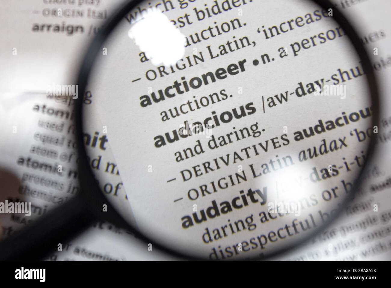 The word of phrase audacious in a dictionary Stock Photo - Alamy