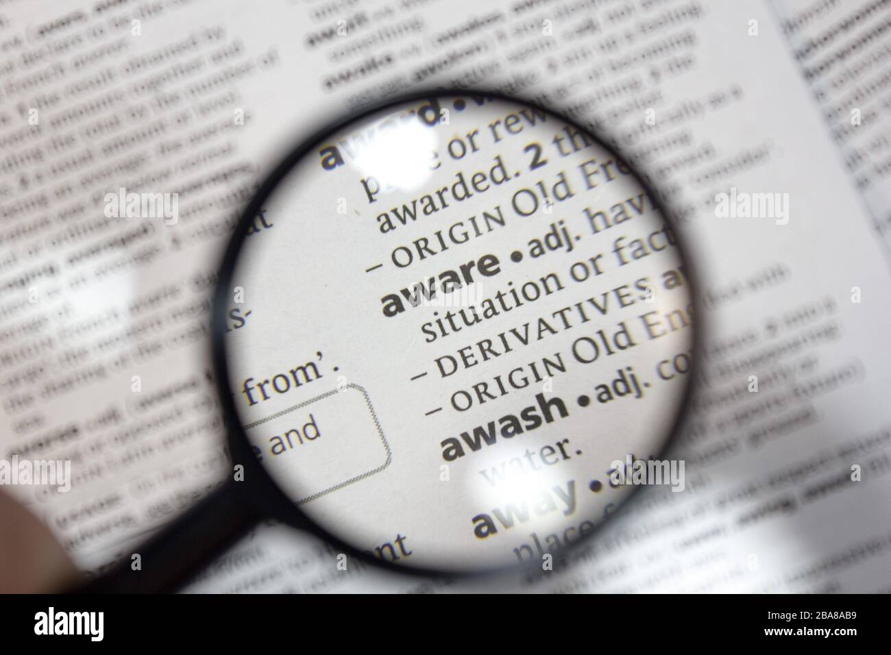 The word of phrase aware in a dictionary Stock Photo - Alamy