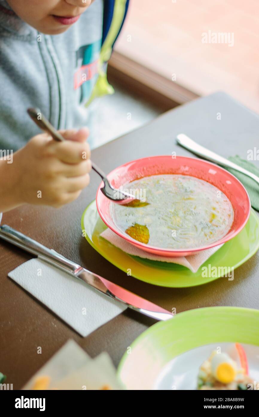 Kid eating a soup, great image for your needs Stock Photo - Alamy