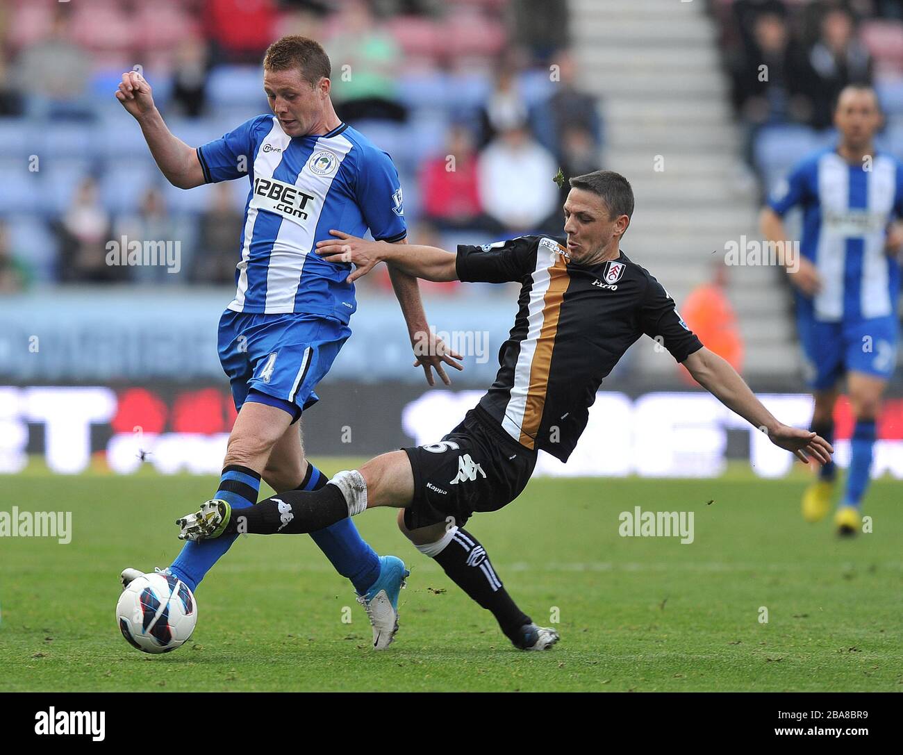 Fulham's Chris Baird (right) battles with Wigan Athletic's James ...