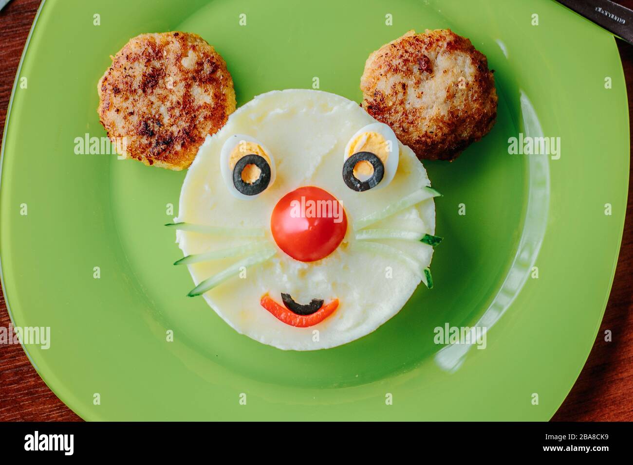 Top view of kid food - funny face made from potato puree and meat ...