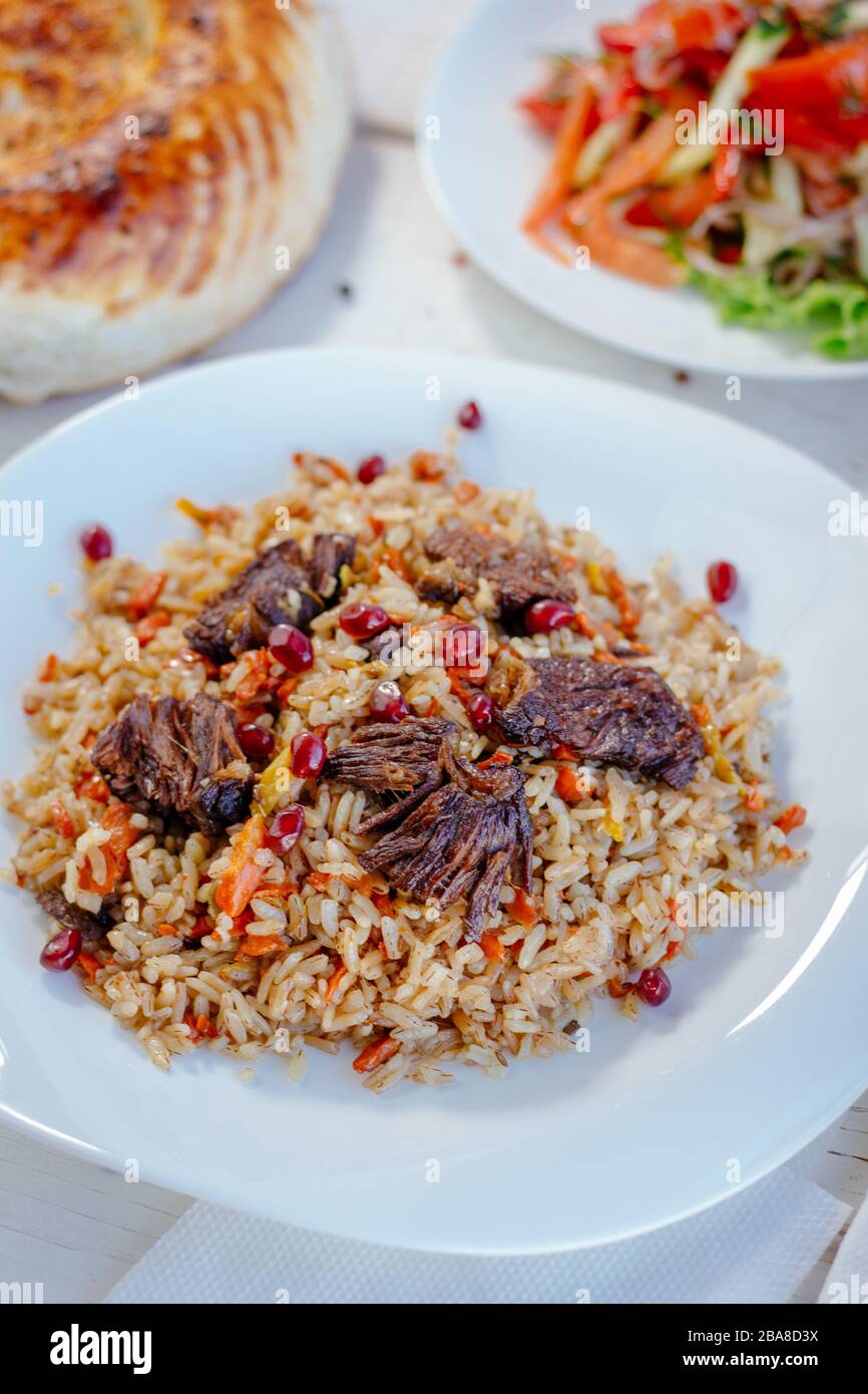 Traditional asian and oriental pilaf or plov with meat on the white ...