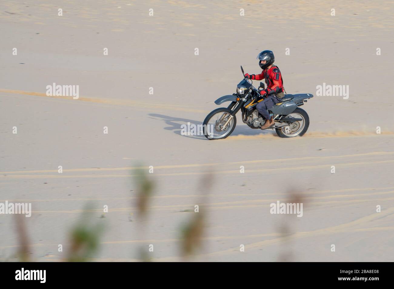 Dirt bike on a sand dune Stock Photo - Alamy