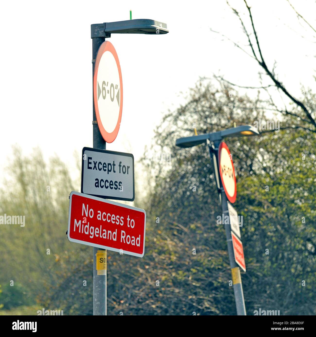Road signs at angles due to road subsidence Stock Photo - Alamy